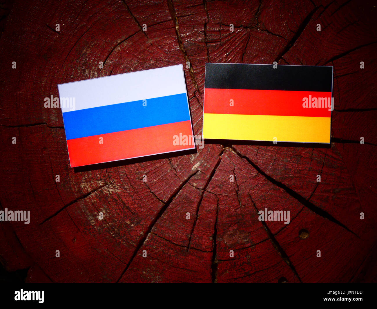 Russian flag with German flag on a tree stump isolated Stock Photo - Alamy