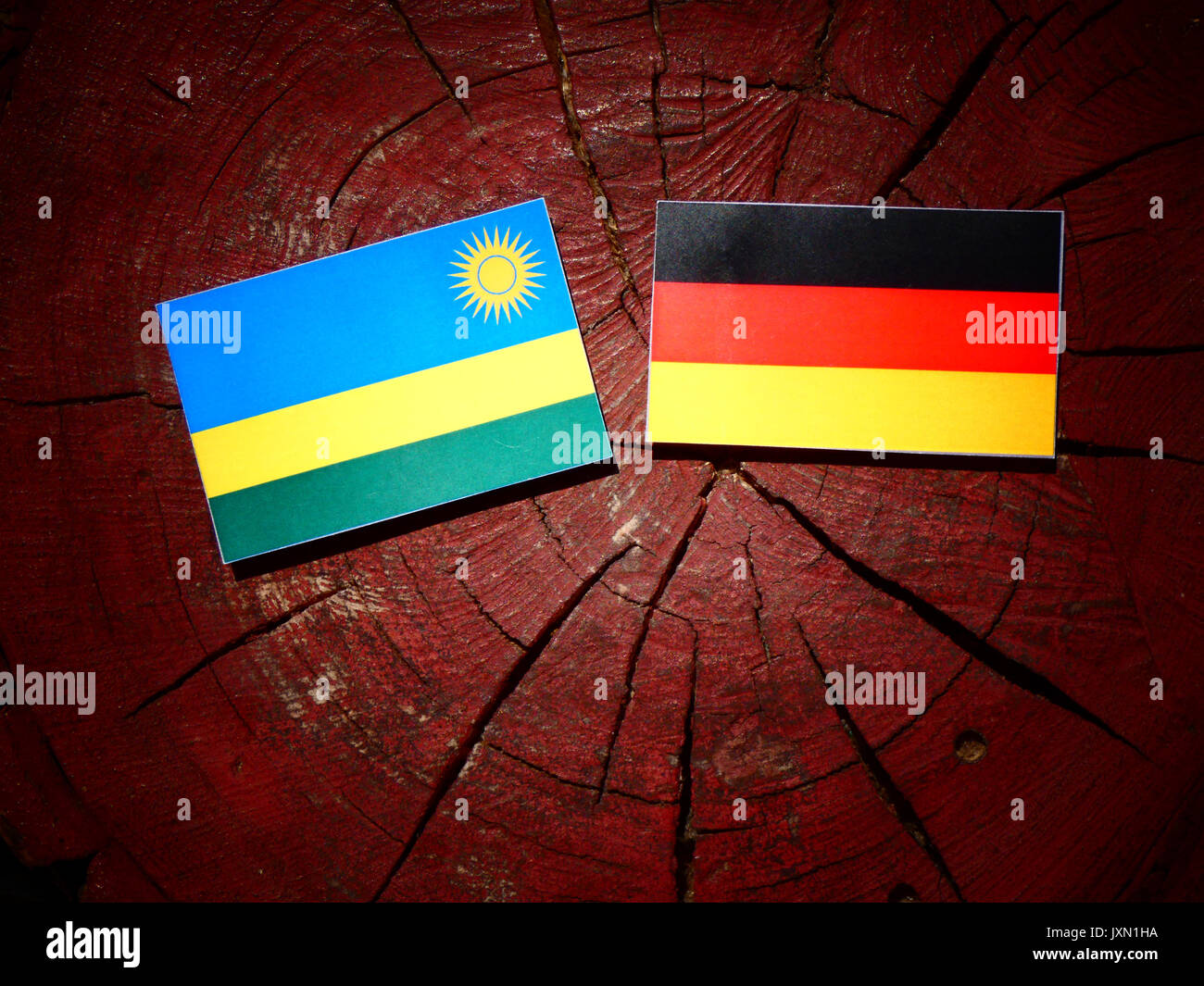 Rwanda flag with German flag on a tree stump isolated Stock Photo - Alamy