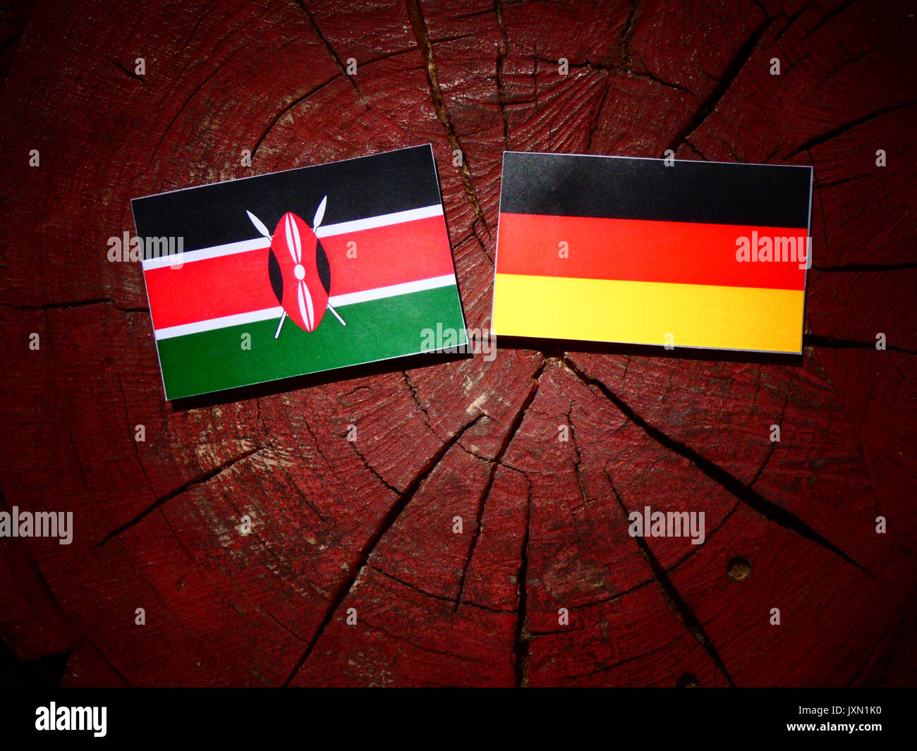 Kenyan flag with German flag on a tree stump isolated Stock Photo - Alamy