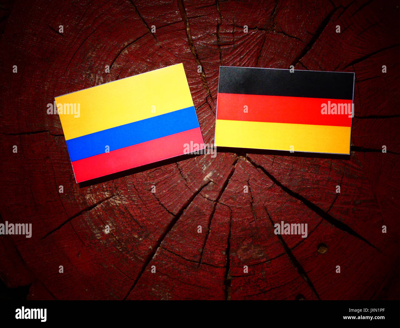 Colombian flag with German flag on a tree stump isolated Stock Photo ...