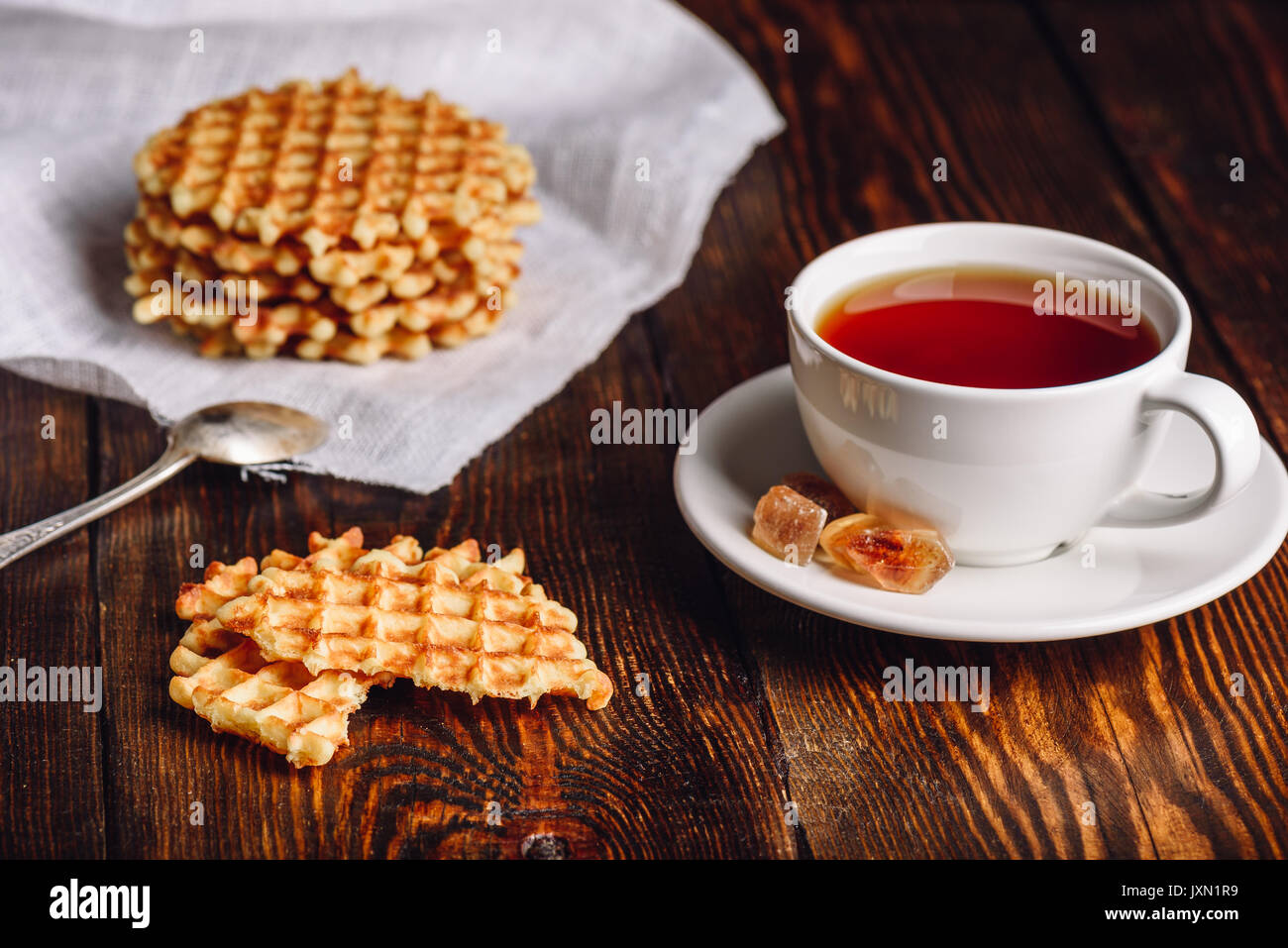 White Cup of Tea with Waffles Stack on Napkin and Pieces of Waffle on ...
