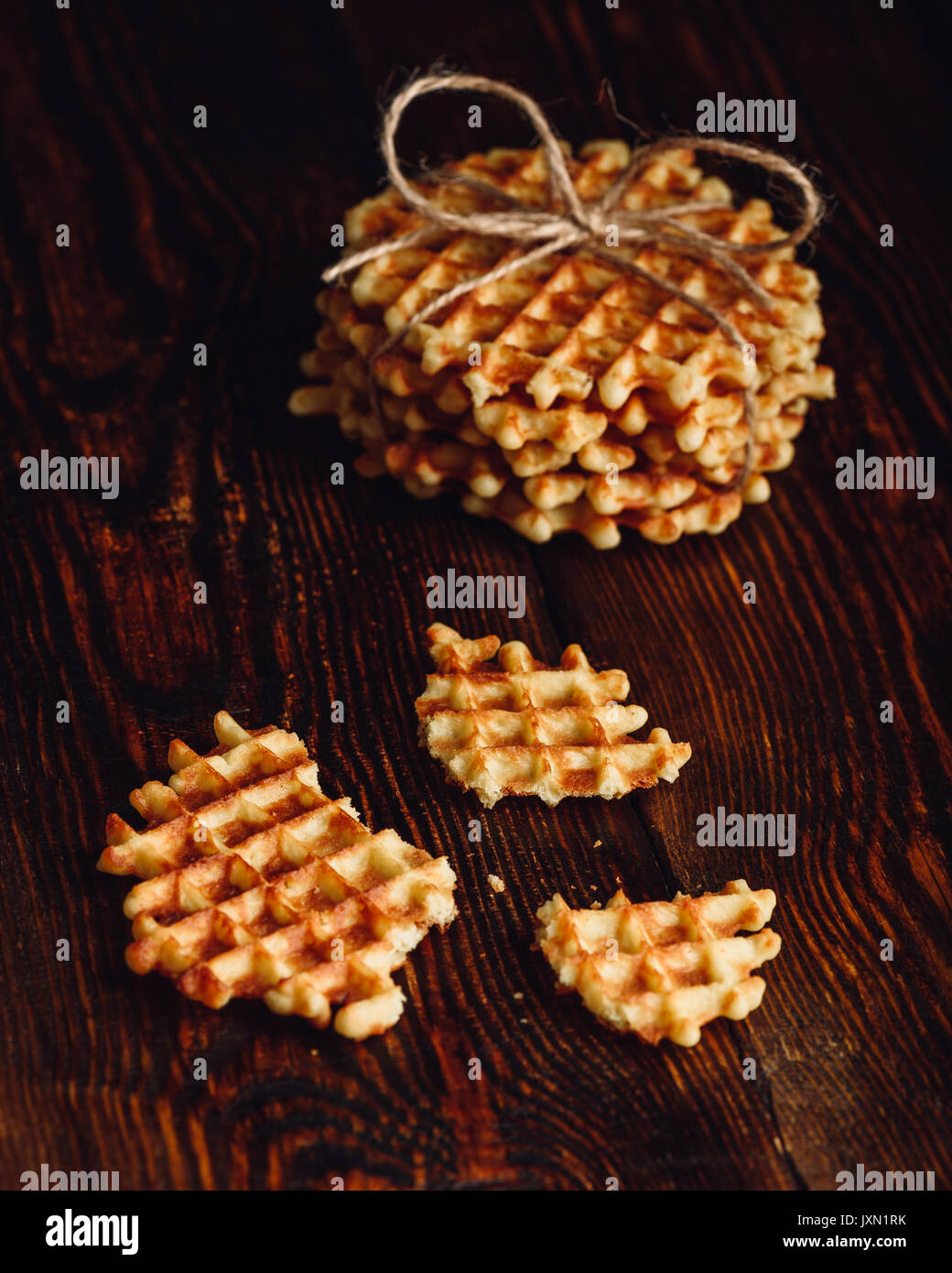 Stack of Belgian Waffles and Waffle Pieces on Wooden Surface. Vertical ...