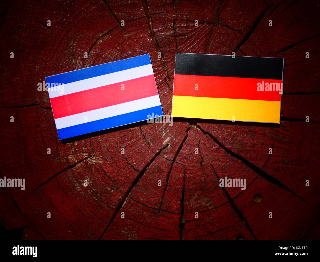 Costa Rican flag with German flag on a tree stump isolated Stock Photo ...