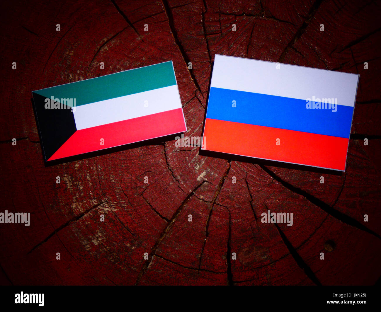Kuwaiti flag with Russian flag on a tree stump isolated Stock Photo - Alamy