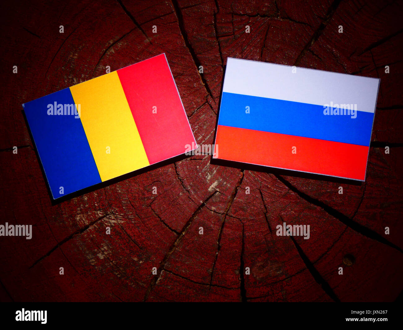 Chad flag with Russian flag on a tree stump isolated Stock Photo - Alamy