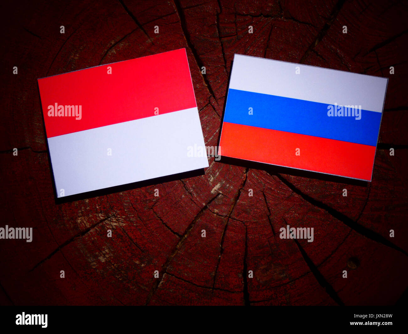Monaco flag with Russian flag on a tree stump isolated Stock Photo - Alamy