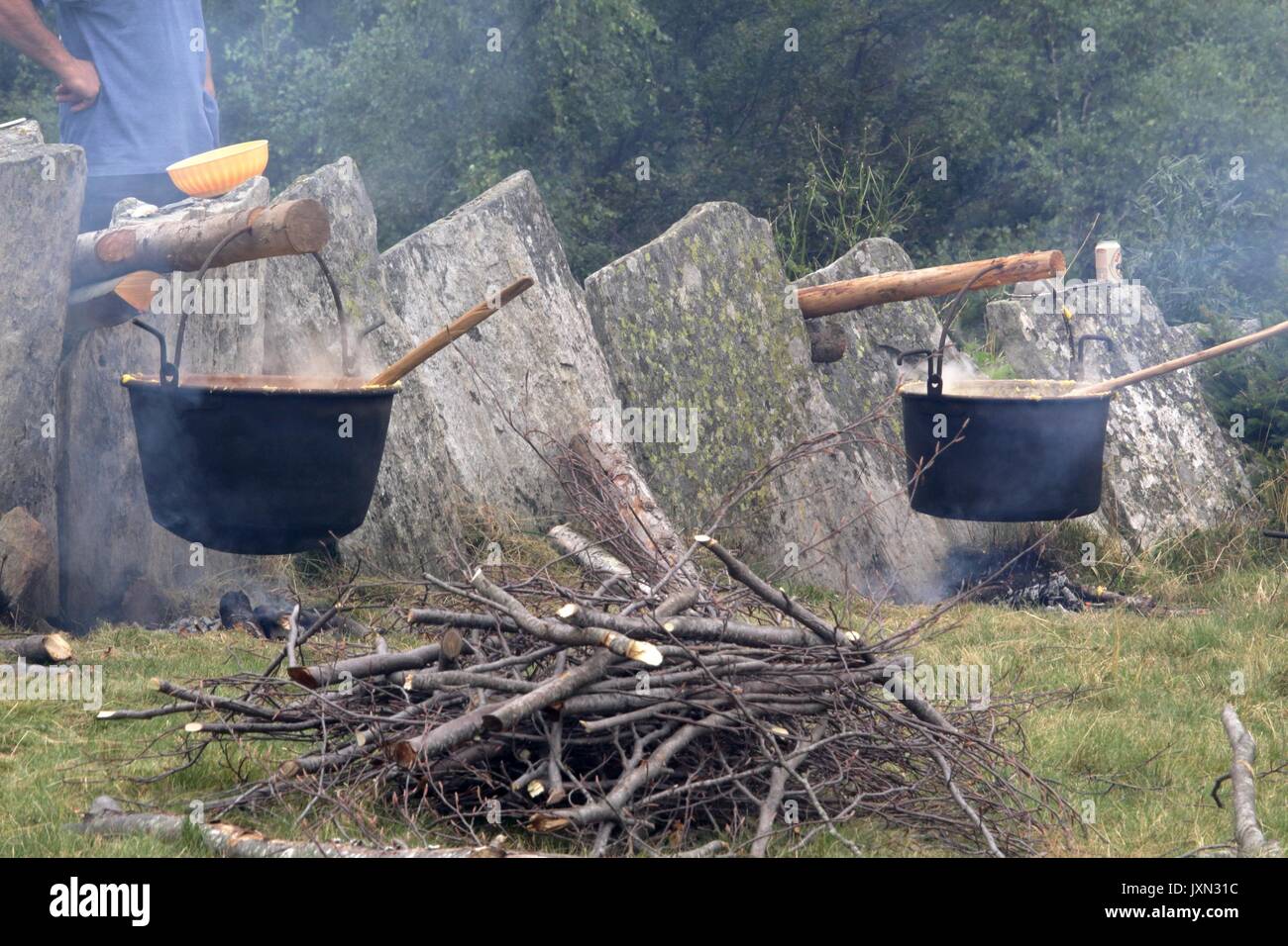 Italian cornmeal polenta (mush) being cooked on slow flame in a pot on ...
