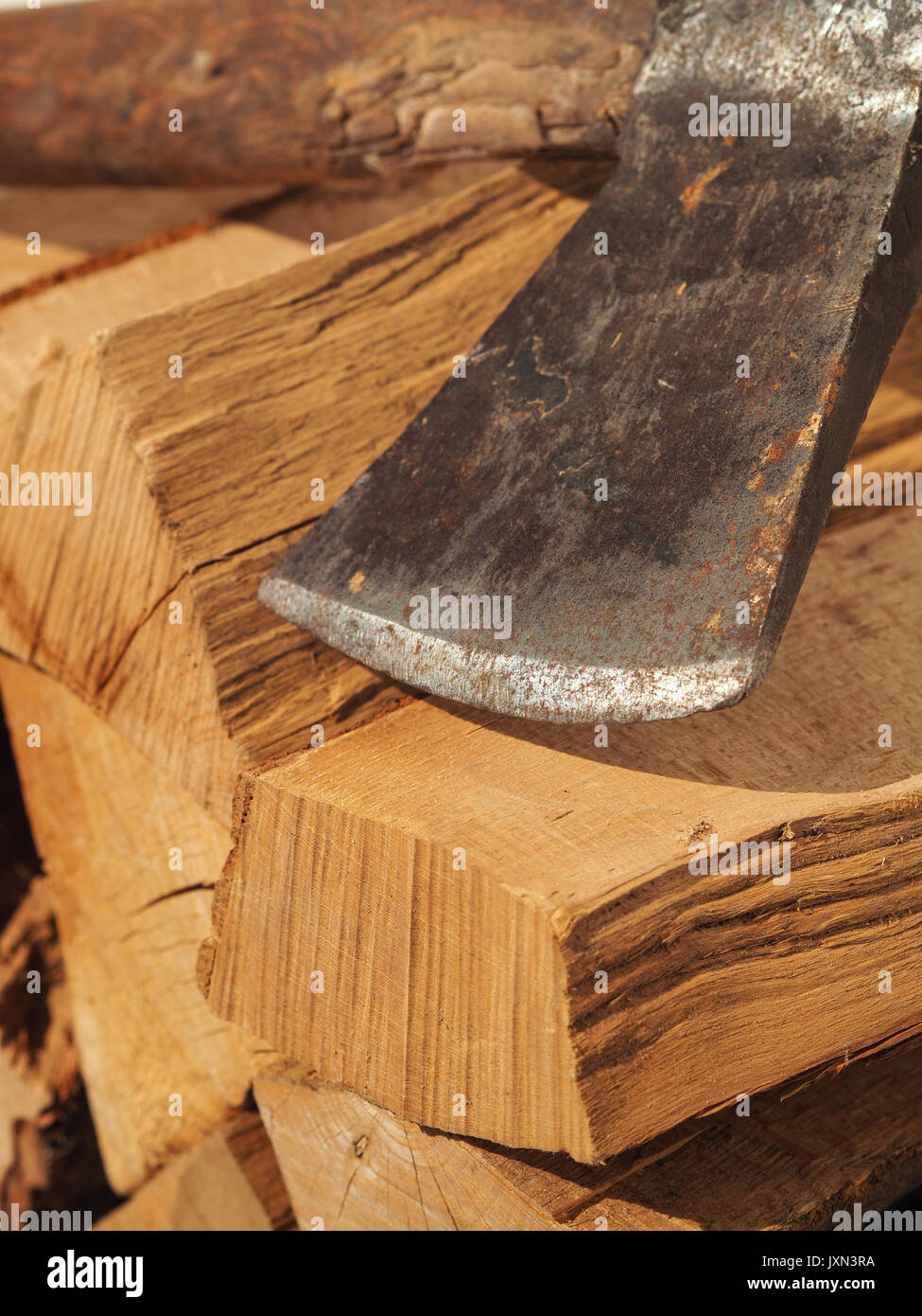 Pile of beech fire wood with an old axe, alternative energy Stock Photo ...