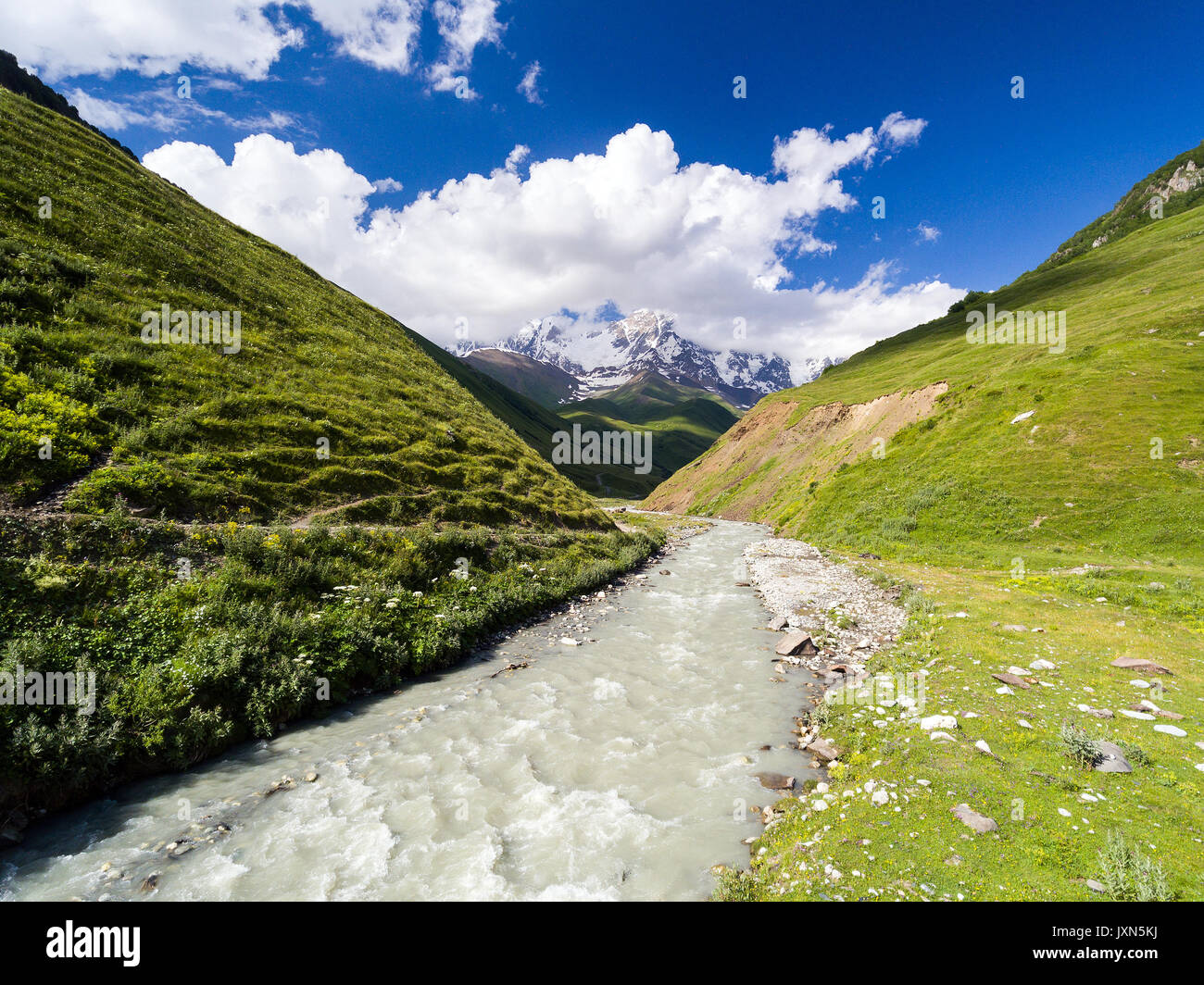 AERIAL.: River in mountain valley at the foot of Mt. Shkhara. Georgia ...