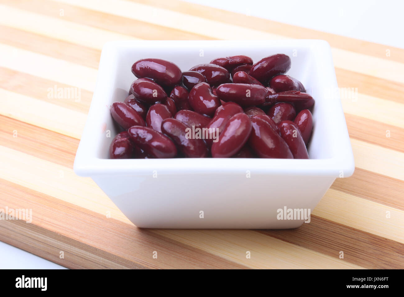 Heap of canned red kidney beans in the sauce in white bowl. vegetarian ...