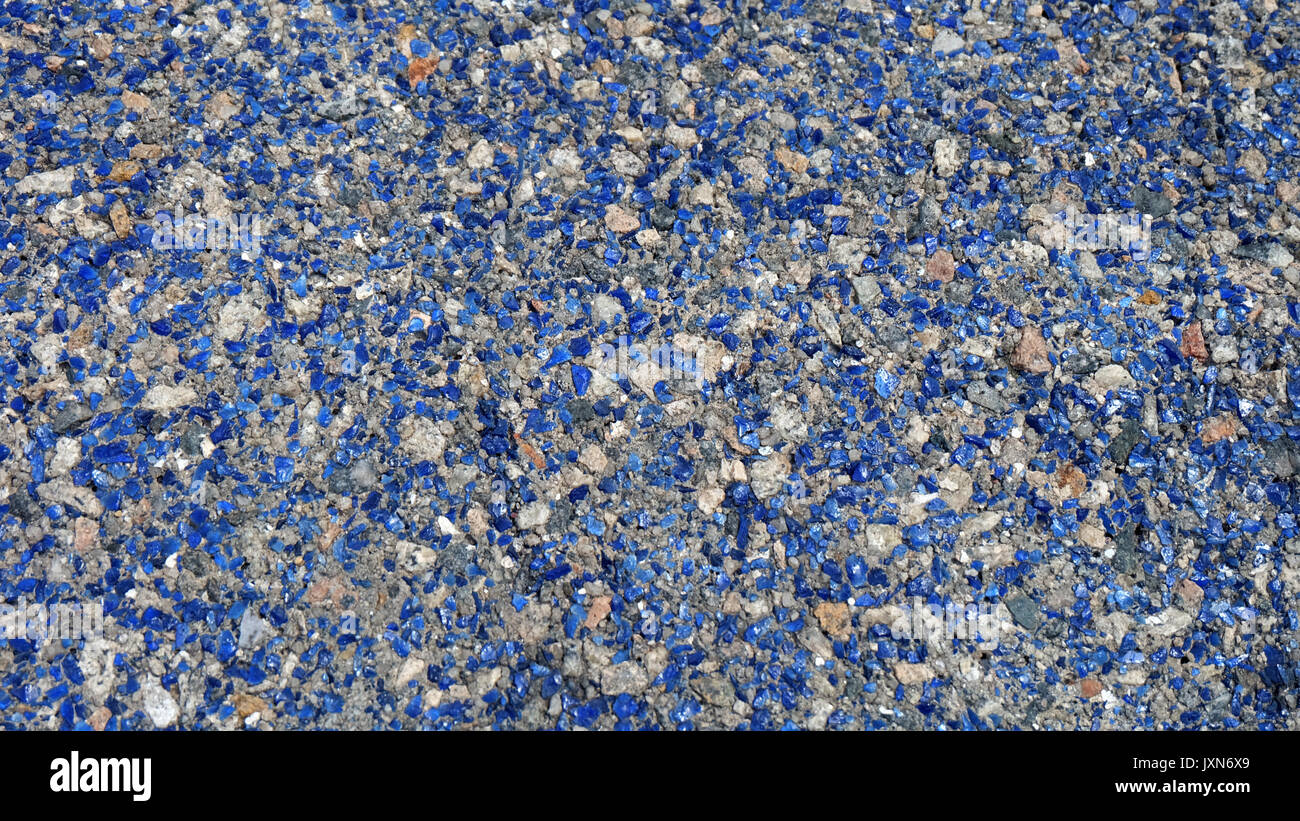 Stone ground lined with small vibrant blue stones or pebbles Stock ...