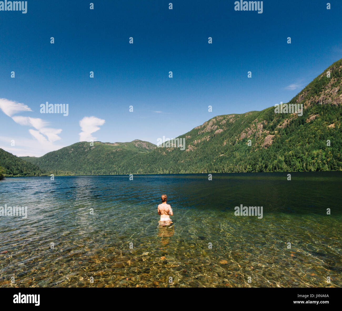 Empty lake with one person Stock Photo - Alamy