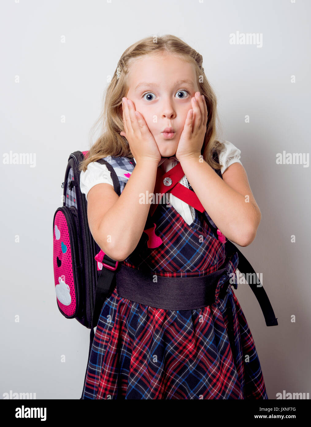 child in a school uniform with a backpack Stock Photo - Alamy