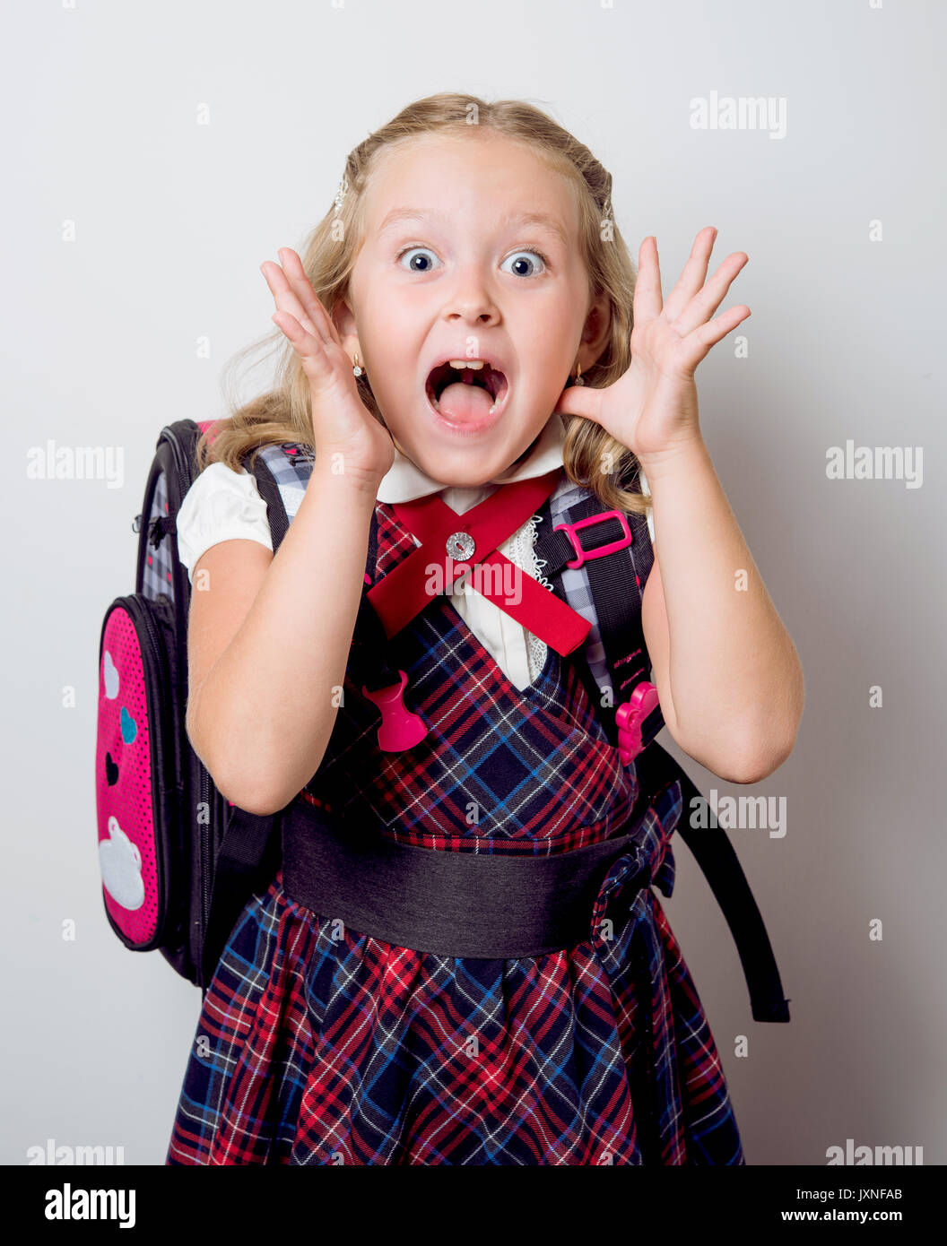 child in a school uniform with a backpack Stock Photo - Alamy
