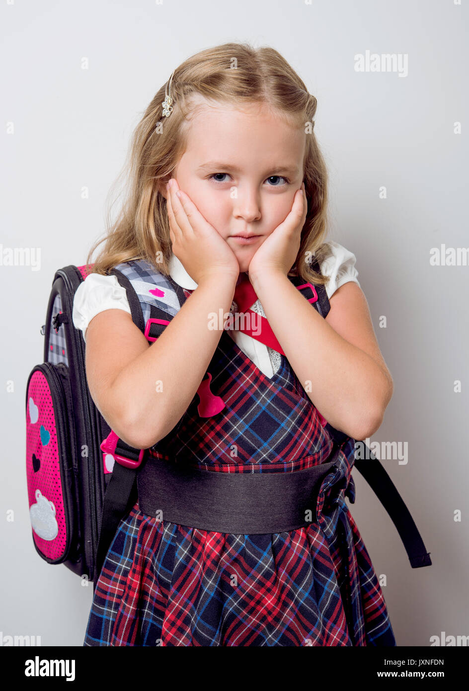 child in a school uniform with a backpack Stock Photo - Alamy