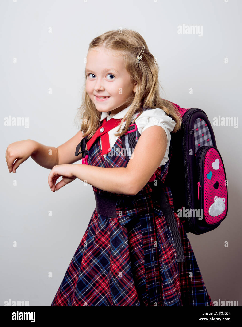 child in a school uniform with a backpack Stock Photo - Alamy