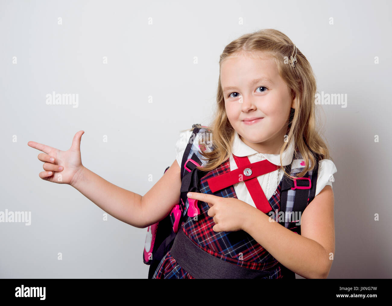 child in a school uniform with a backpack Stock Photo - Alamy