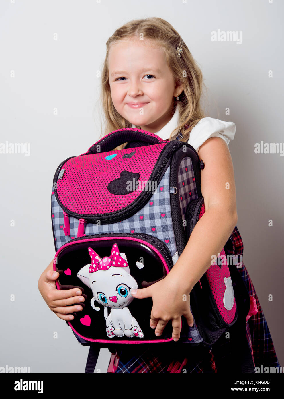 child in a school uniform with a backpack Stock Photo - Alamy