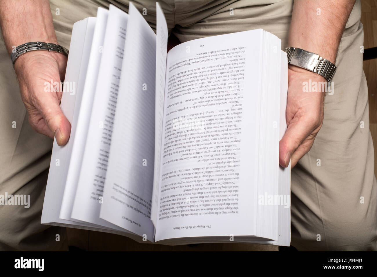 A man flicking through the pages of a book Stock Photo - Alamy