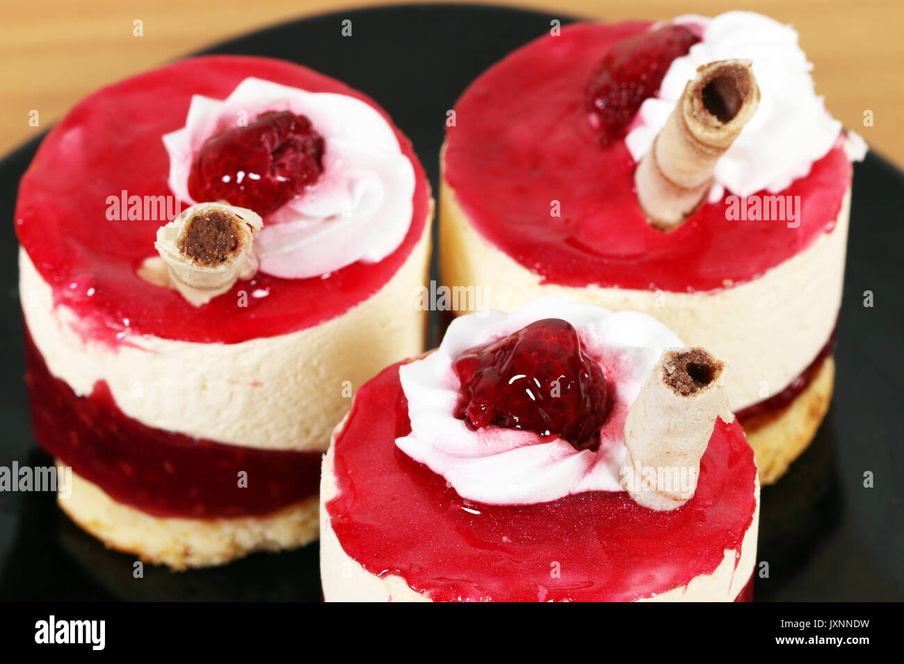 three sweet raspberry cakes closeup Stock Photo - Alamy