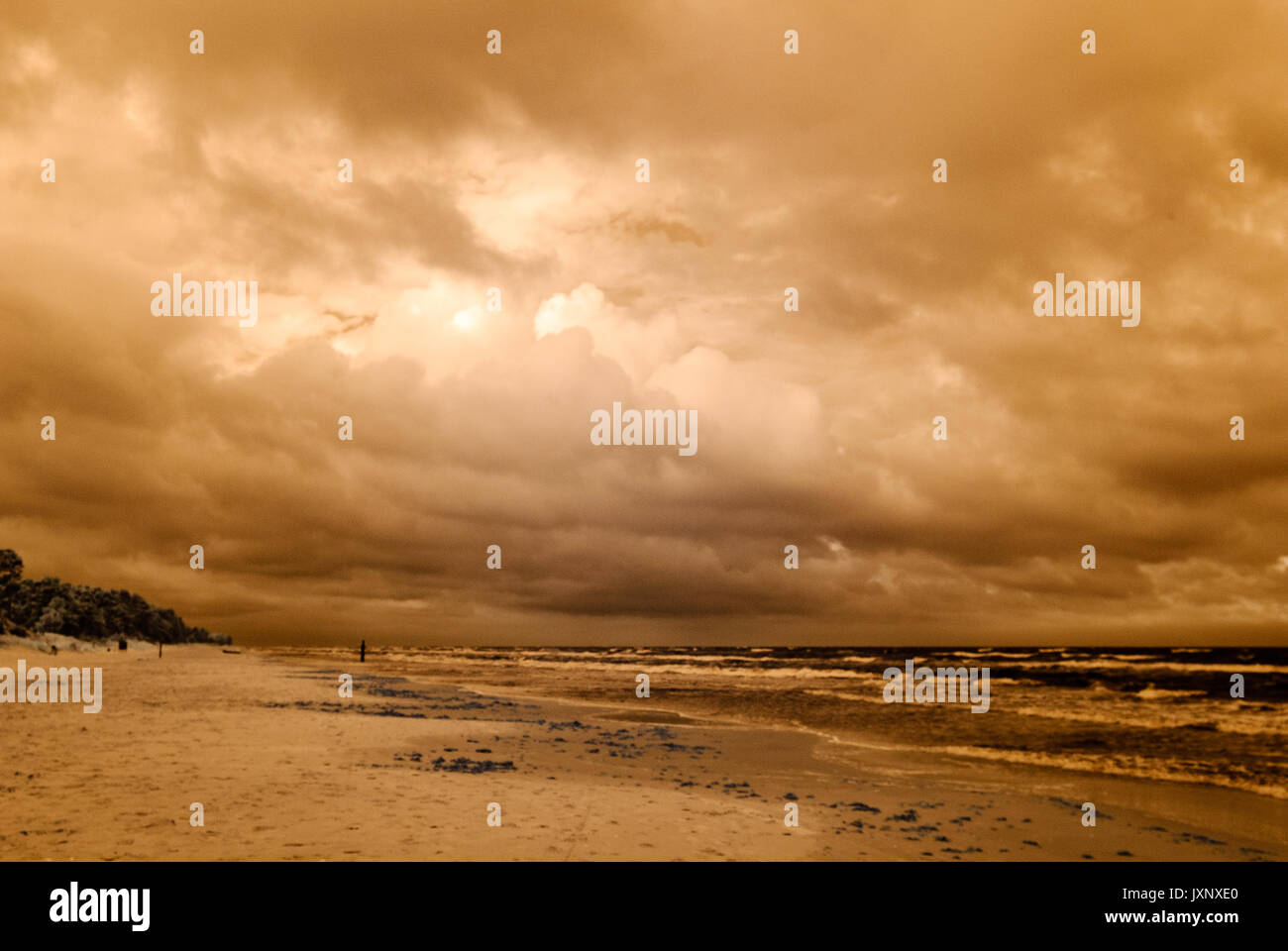 sea beach with dramatic clouds in summer. infrared image Stock Photo ...