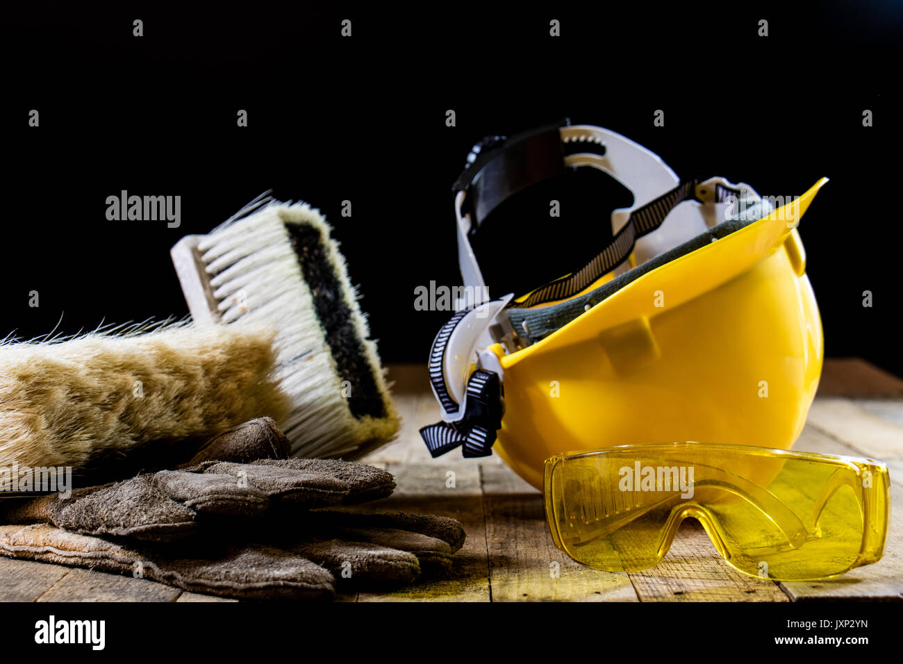 Yellow helmet and carpenter tools. Carpenter and old wooden table ...