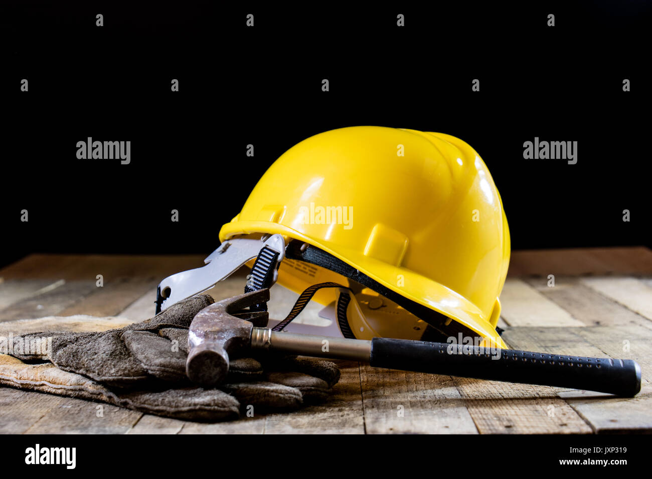 Yellow helmet and carpenter tools. Carpenter and old wooden table ...