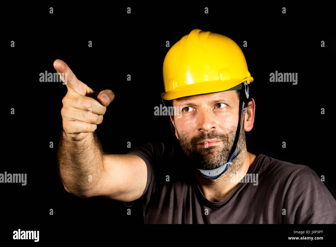 Worker, employee in a helmet. Black beard, black background. Yellow ...