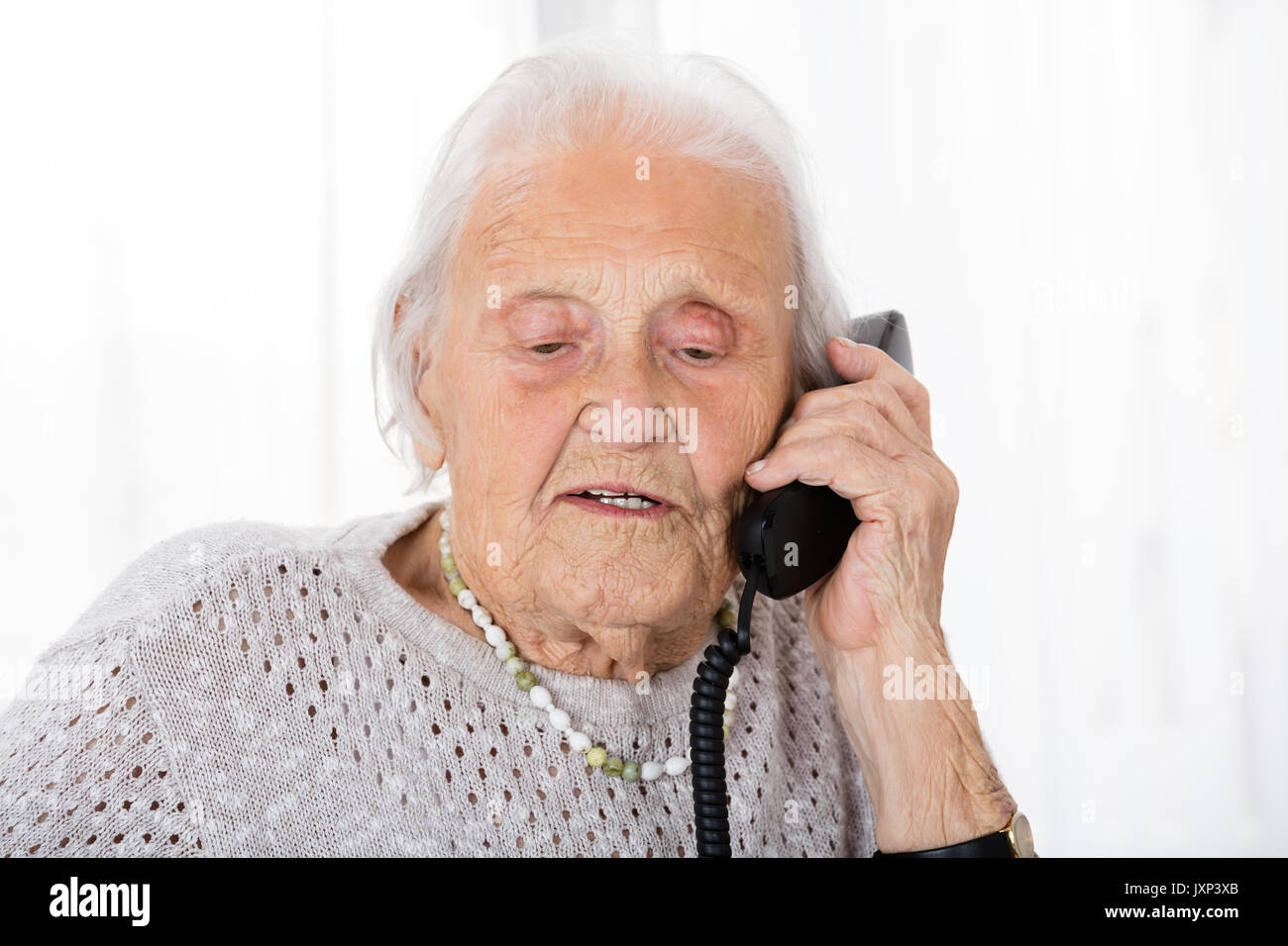 Portrait Of Senior Woman Having Conversation On Landline Phone Stock ...
