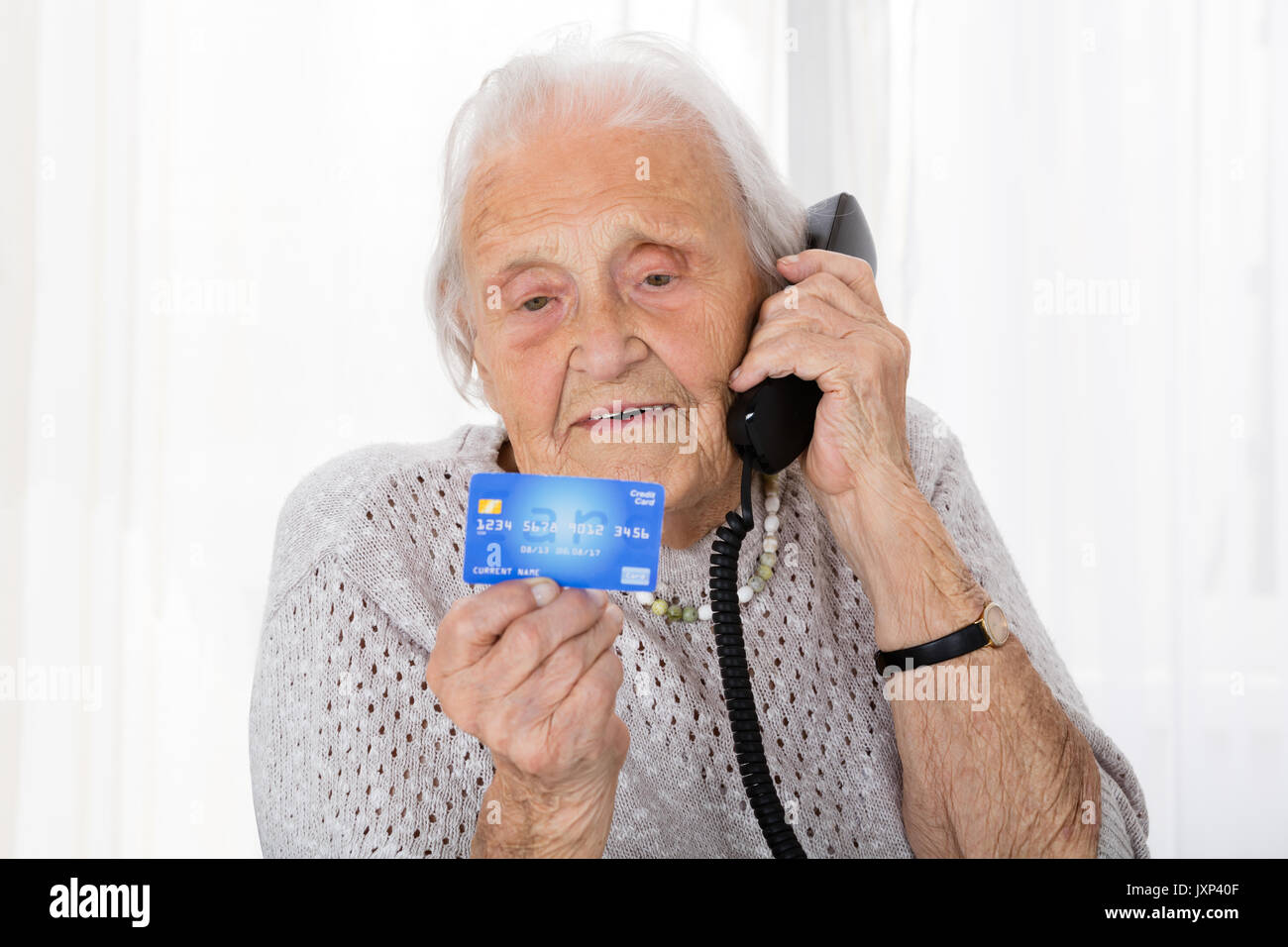 Portrait Of Senior Woman Giving Credit Card Details On The Phone Stock ...