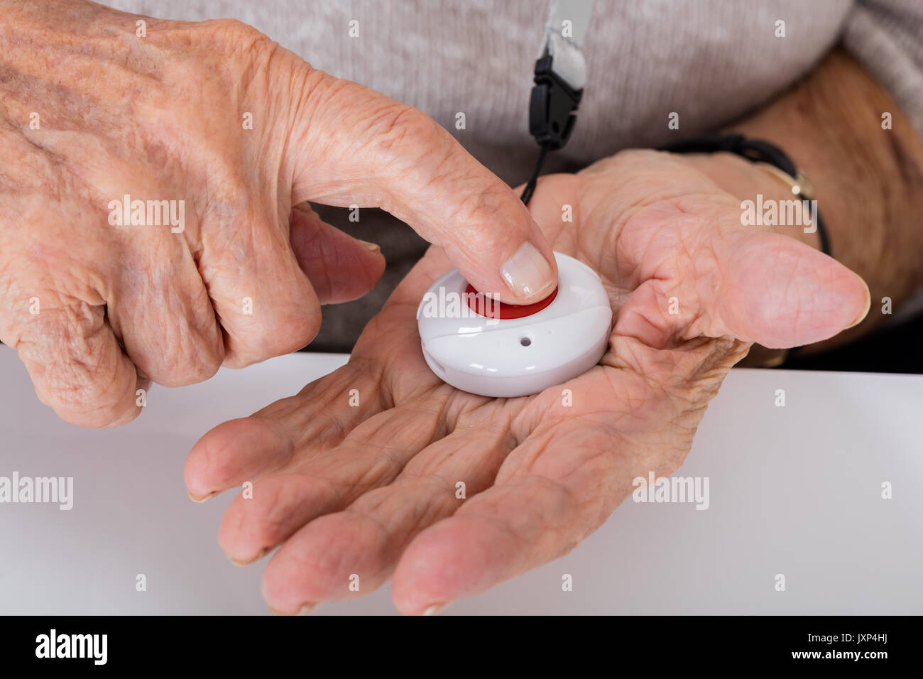 Close-up Of Senior Woman Pressing Alarm Button For Emergency Stock ...