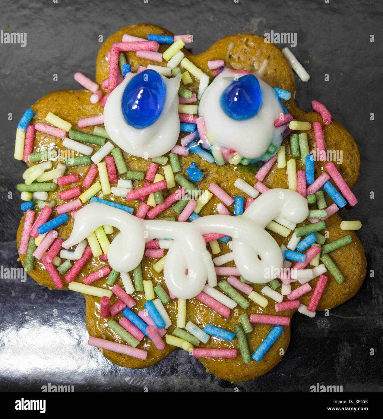 Freshly made homemade gingerbread man face ginger cookie decorated with ...