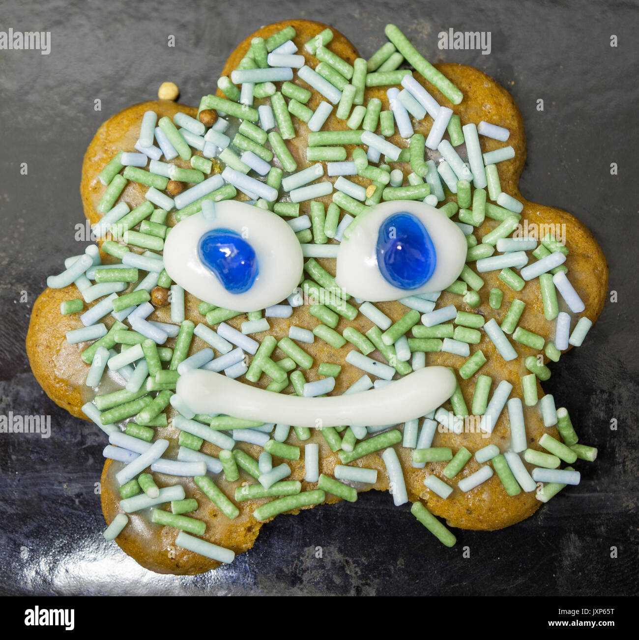 Freshly made homemade gingerbread man face ginger cookie decorated with ...