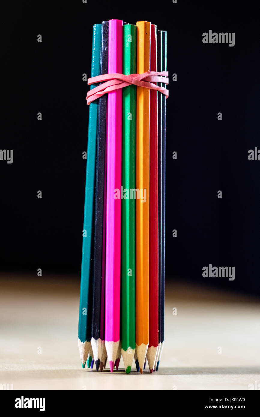 Beautiful and colorful pencil crayons. Wooden table. Black background ...