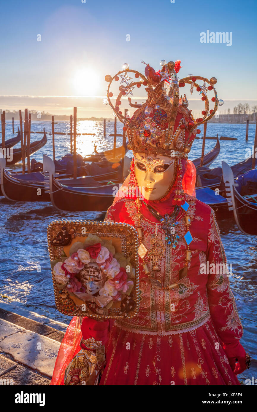 Carnival masks with mirror against dondolas in Venice, Italy Stock ...