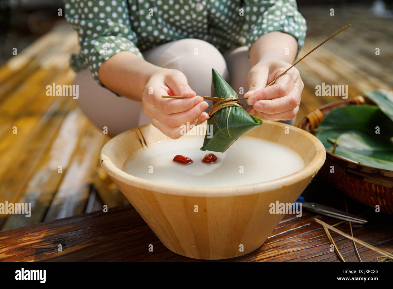 Middle-aged women are making zongzi Stock Photo - Alamy