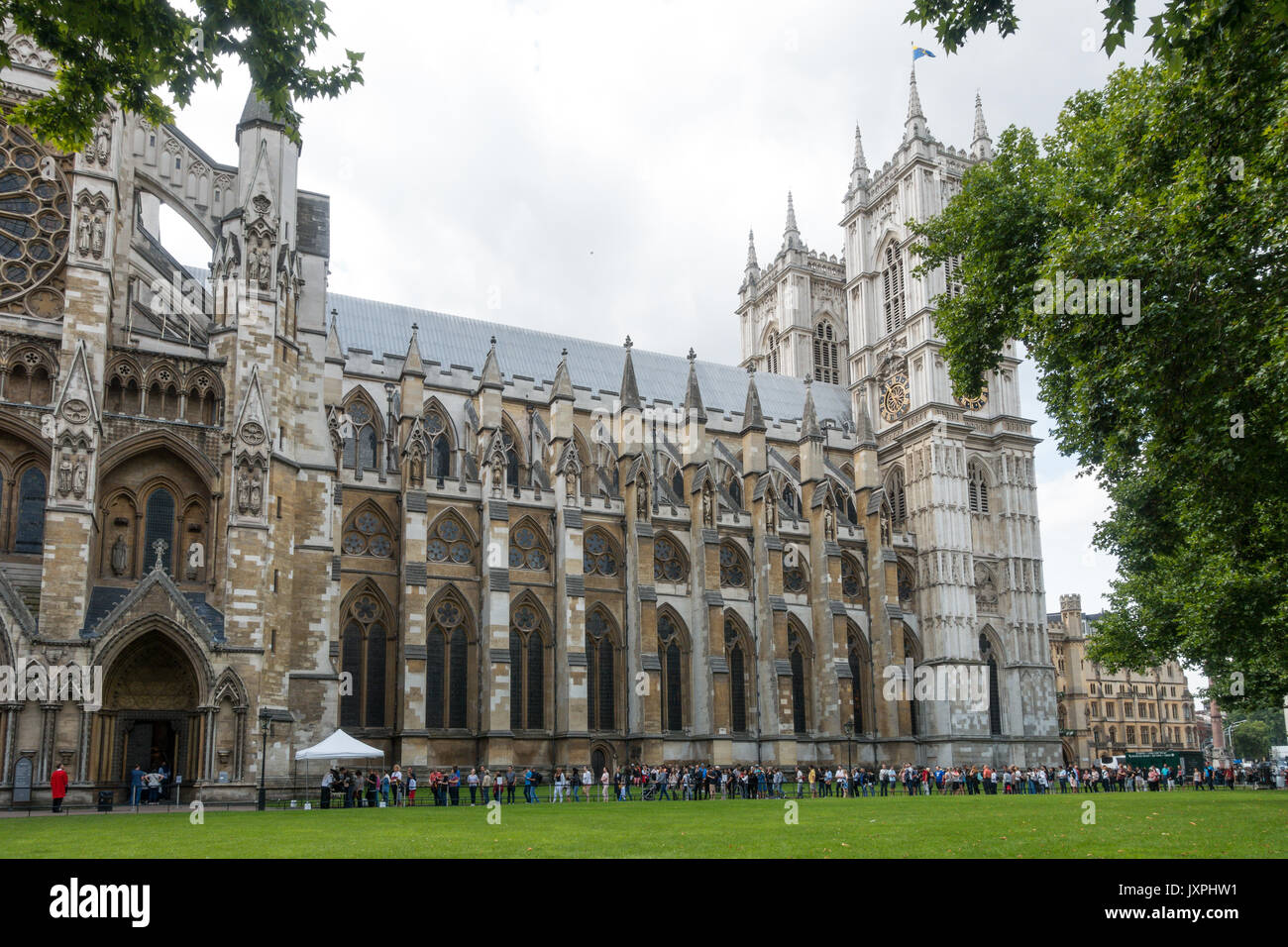 View of Westminster Abbey with tourists queuing for the entrance, Westminster, London SW1P 3PA ...