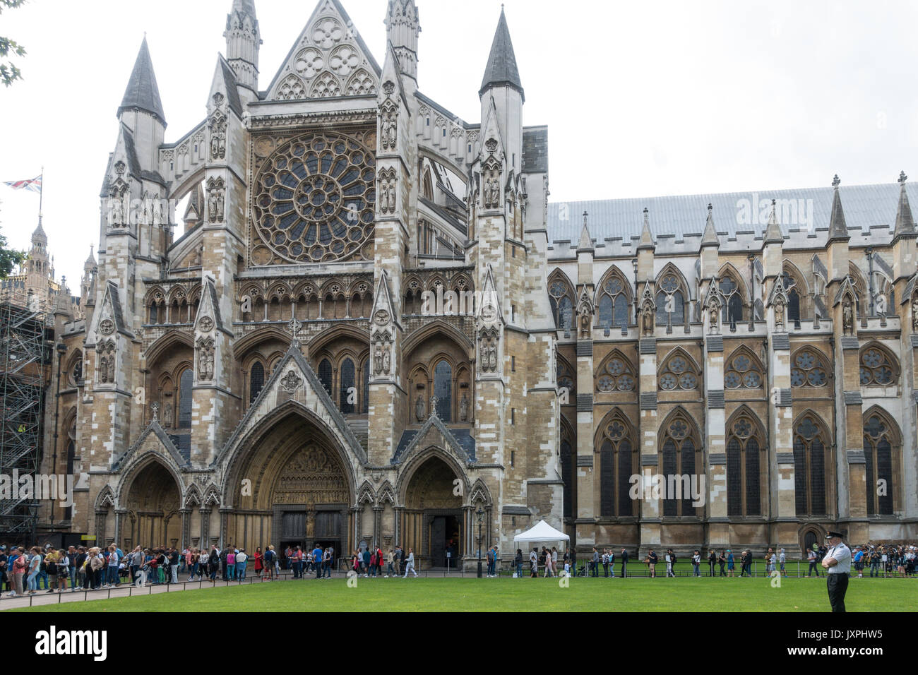 View of Westminster Abbey with tourists queuing for the entrance, Westminster, London SW1P 3PA ...