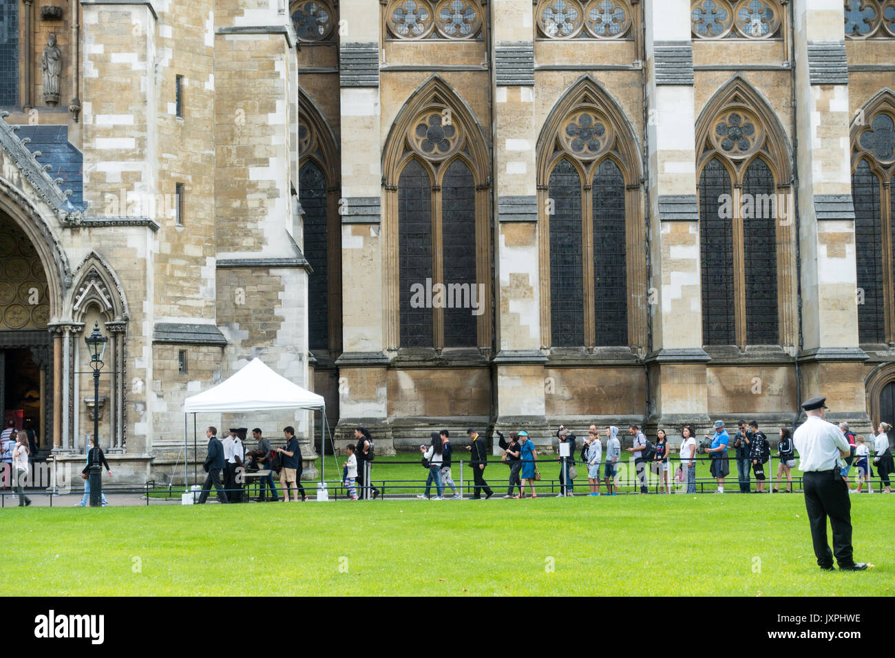 View of Westminster Abbey with tourists queuing for the entrance, Westminster, London SW1P 3PA ...
