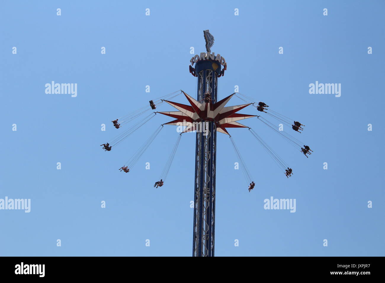 View of swings ride at theme park in Spain Stock Photo - Alamy