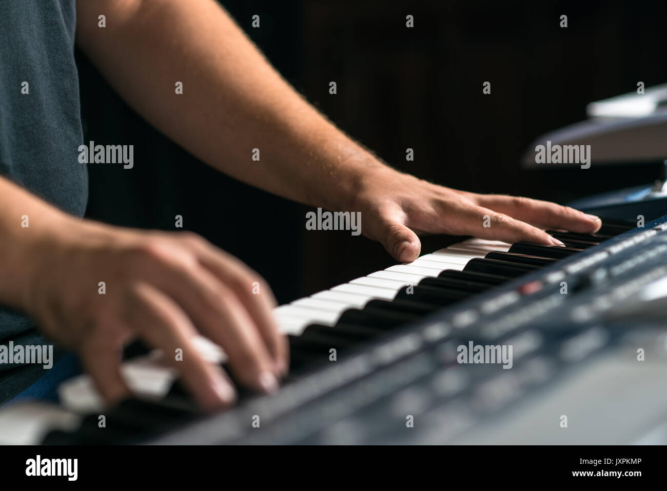 A musician plays the keyboard musical instrument Stock Photo - Alamy