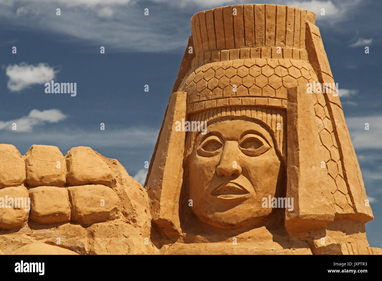 Sand sculpture: aztec or maya stylized man head with cloudy sky as a ...