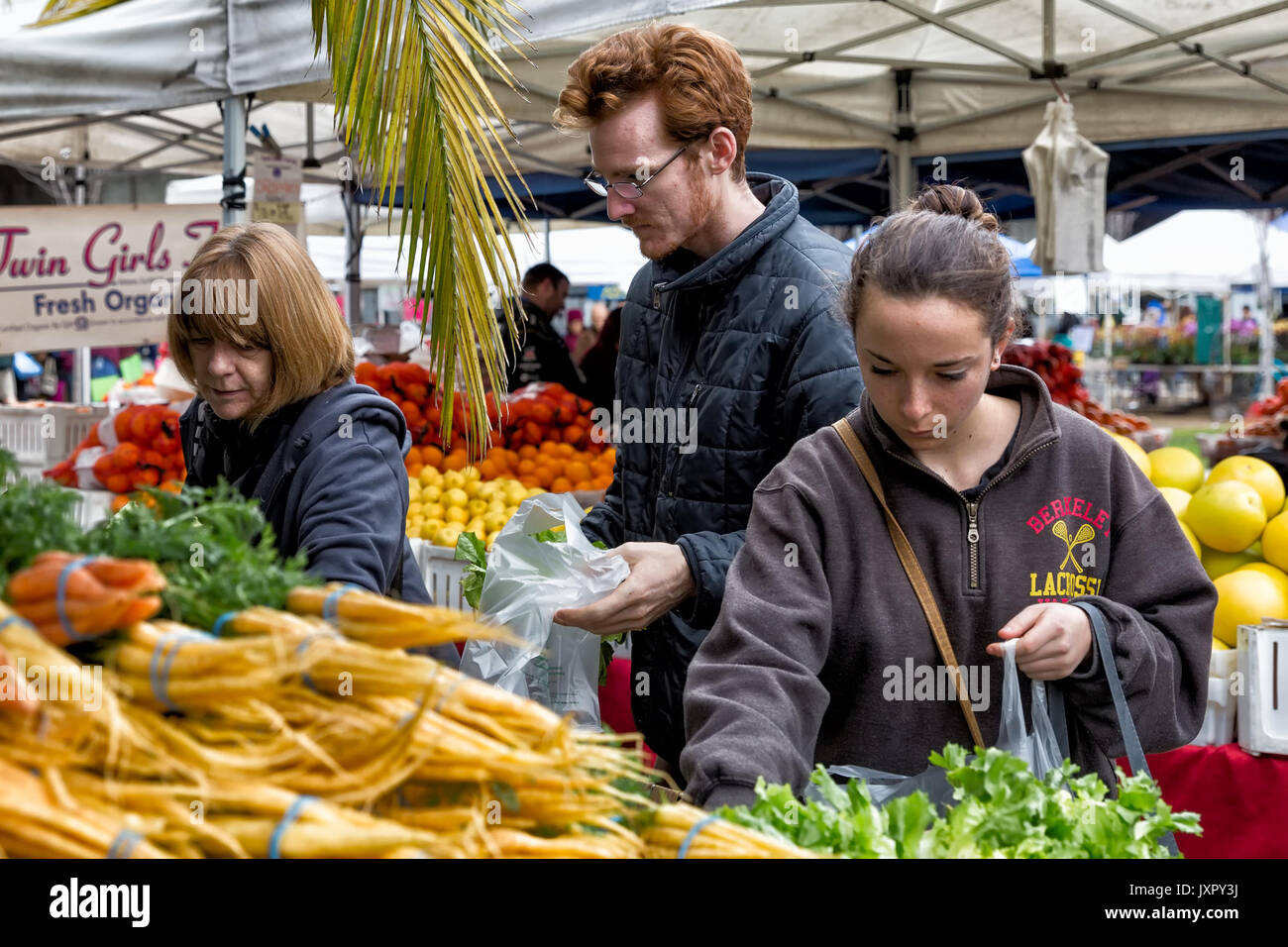 OAKLAND, CA - JAN 11, 2014: Shoppers select fresh produce at the Grand ...