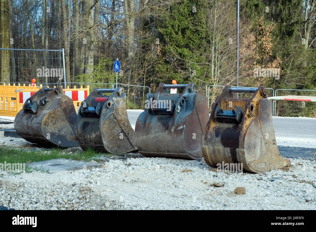 excavator buckets lying at construction site Stock Photo - Alamy