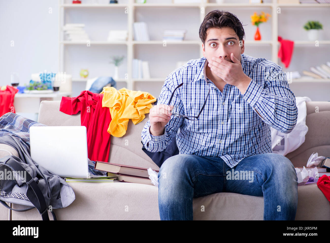 Young man working studying in messy room Stock Photo - Alamy