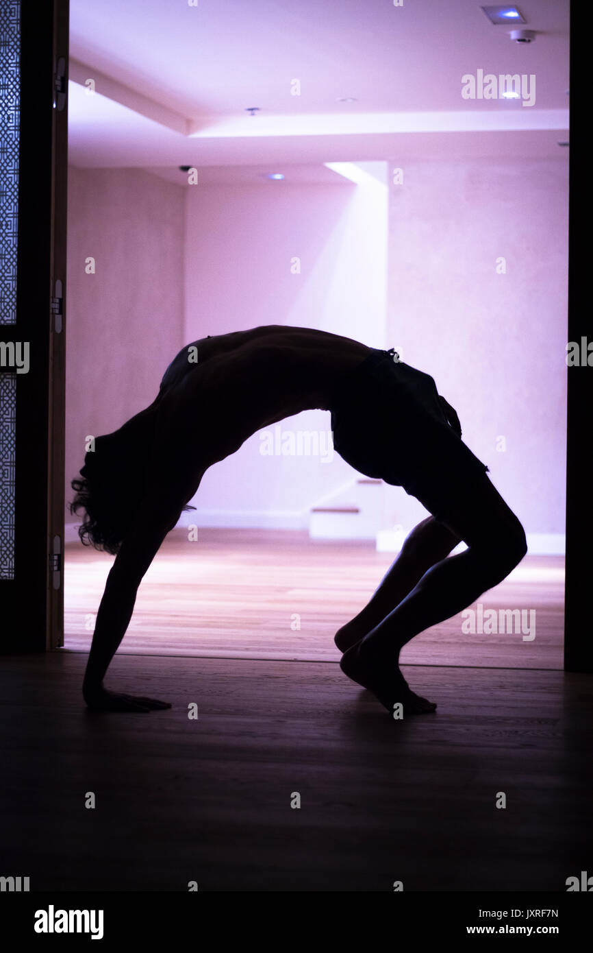 Yoga teacher doing backbend bridge flexibility and strength asana ...