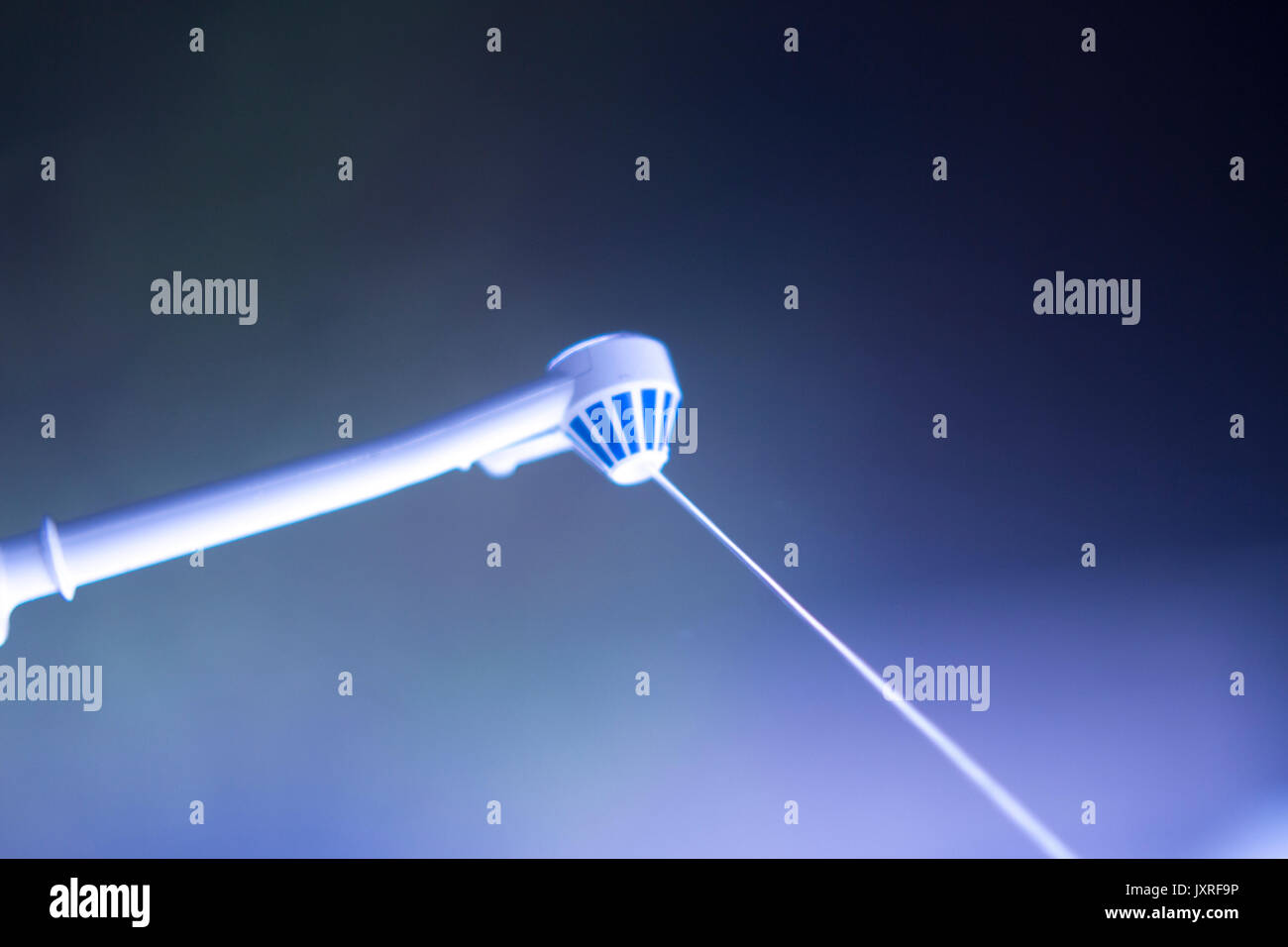 Dental water spray cleaner for interdental hygiene Stock Photo - Alamy