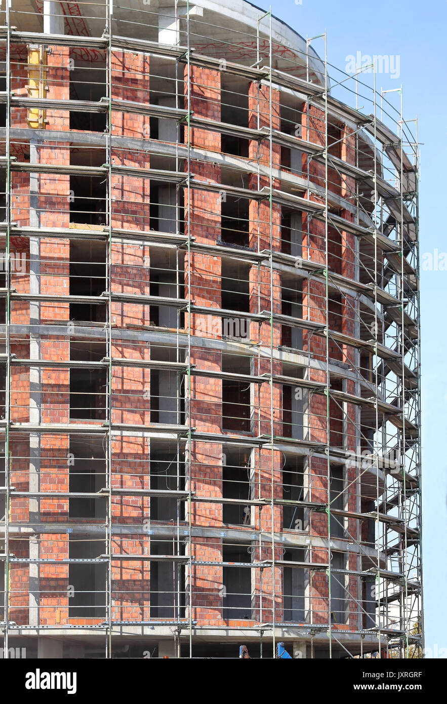 Construction of tall building with metal scaffolds Stock Photo - Alamy