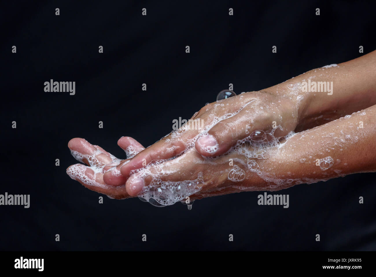 Washing hands isolated on black Stock Photo - Alamy