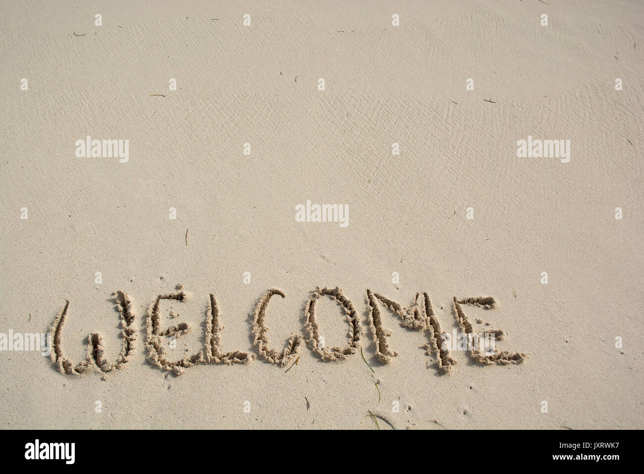Welcome written in a sandy tropical beach Stock Photo - Alamy